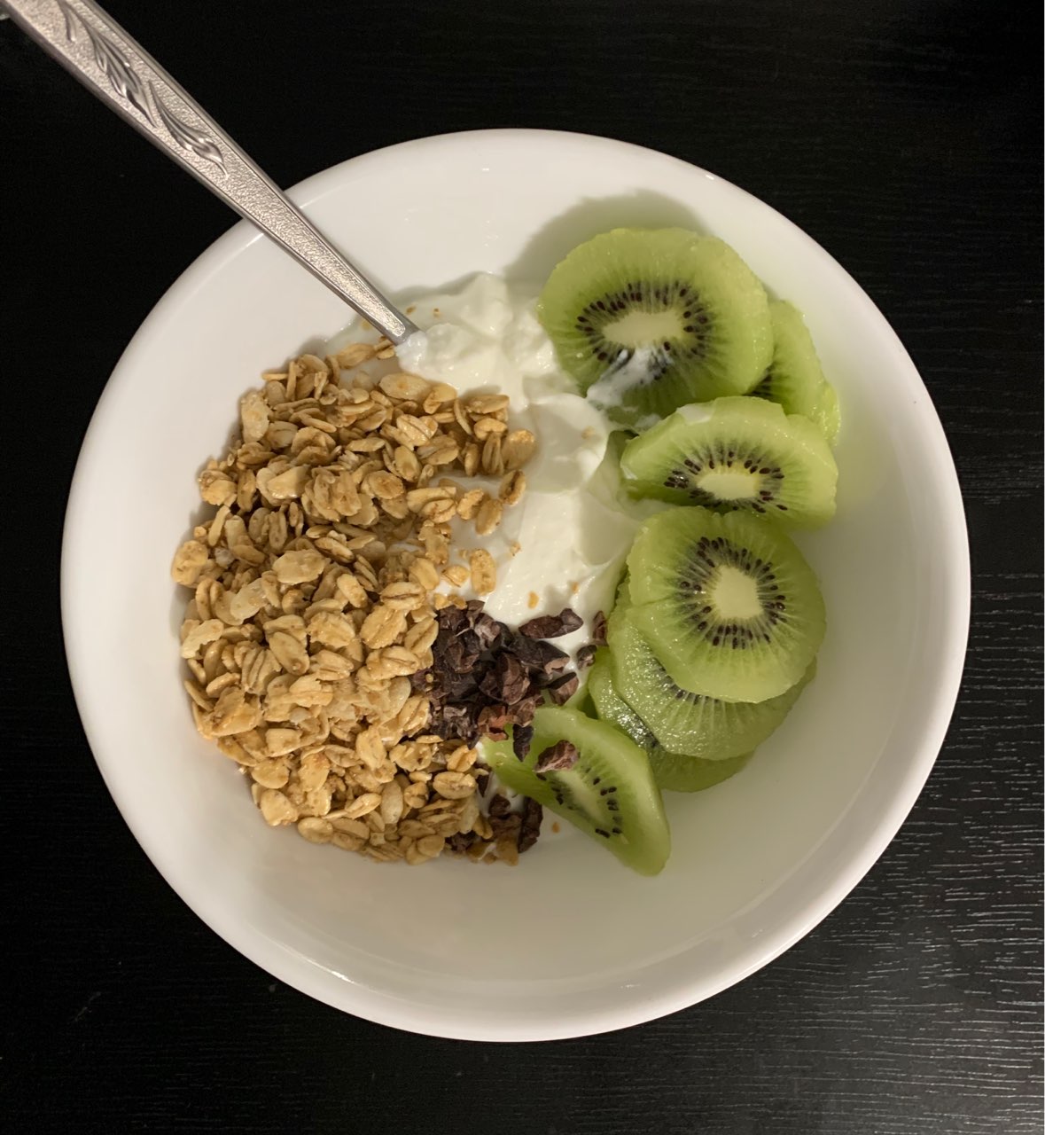 Plain Greek yogurt with kiwi, granola, and cacao nibs for post-workout ...